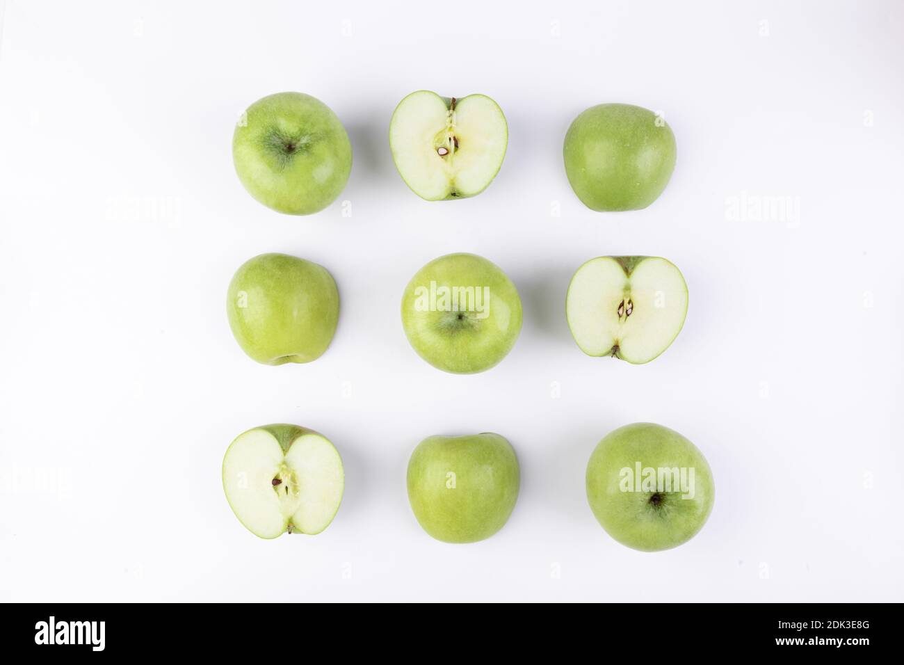 A top view of fresh sliced green apples isolated on white background ...