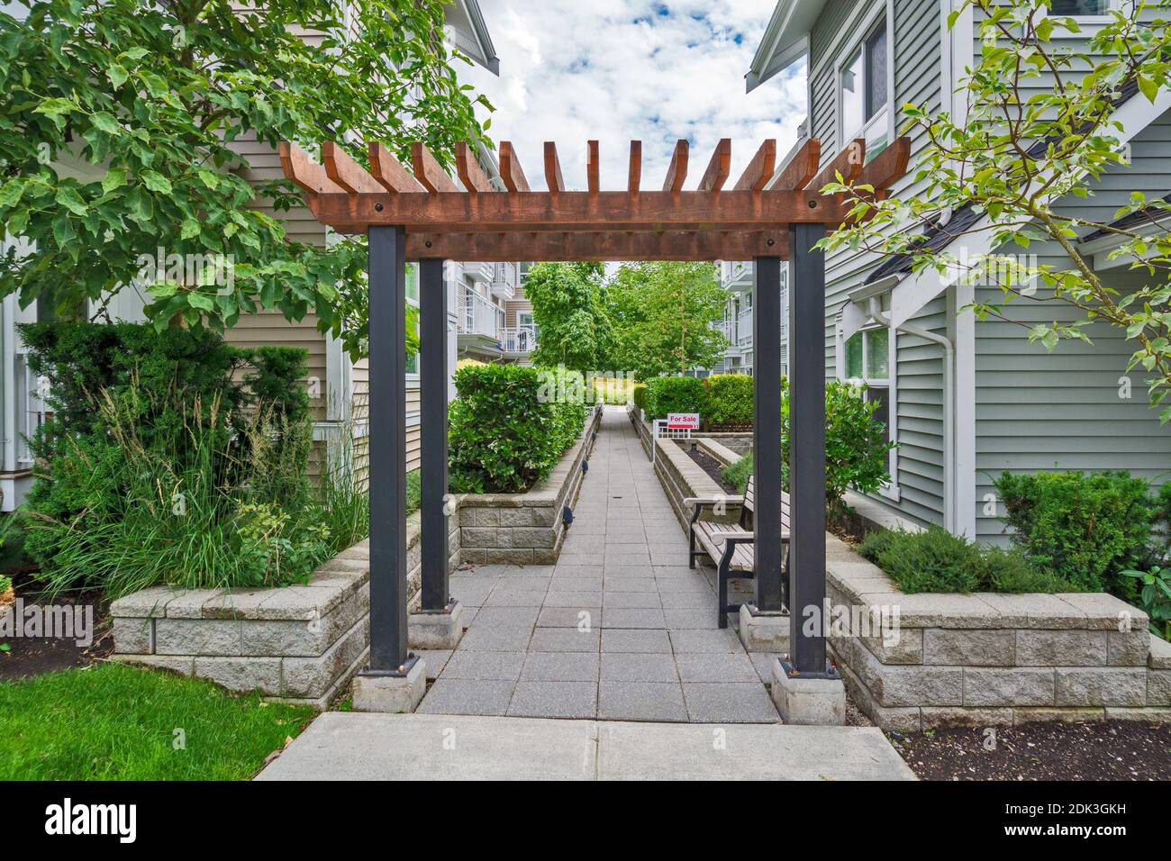 Walkway in residential area between two rows of townhouses with unit ...