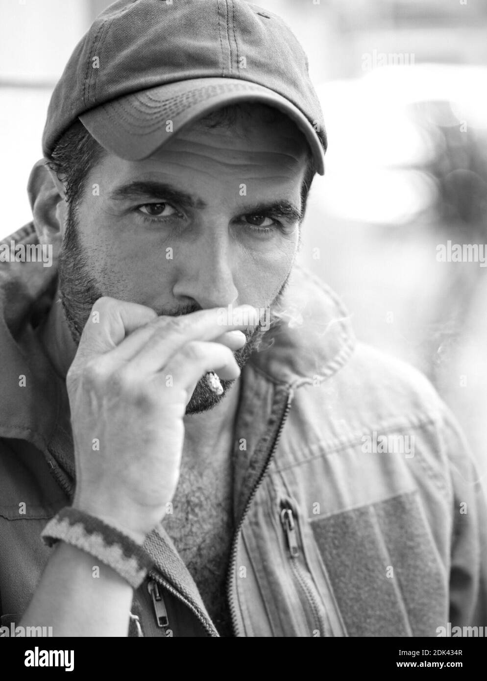 Handsome man smoking cigarette hi-res stock photography and images - Alamy