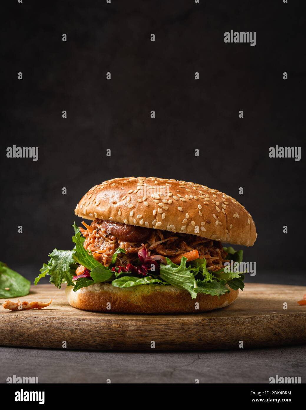 A vertical closeup shot of a delicious sandwich on a chopping board ...