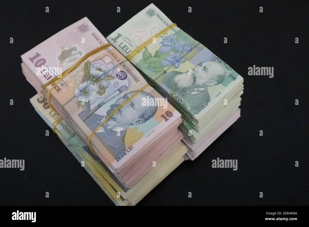 Romanian leu banknotes on a black background Stock Photo - Alamy