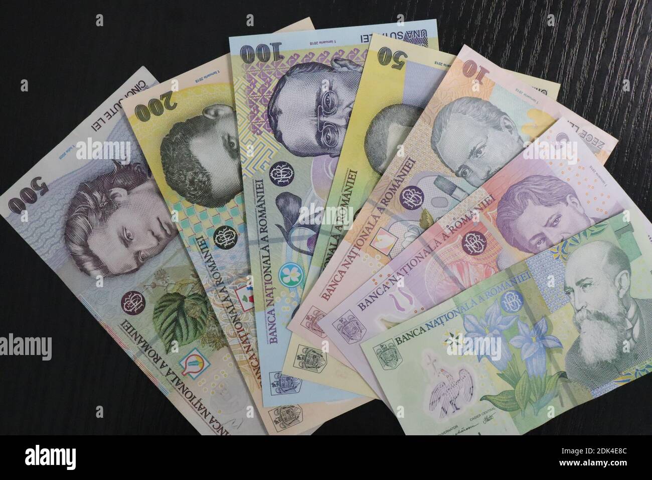 Romanian leu banknotes on a black background Stock Photo - Alamy