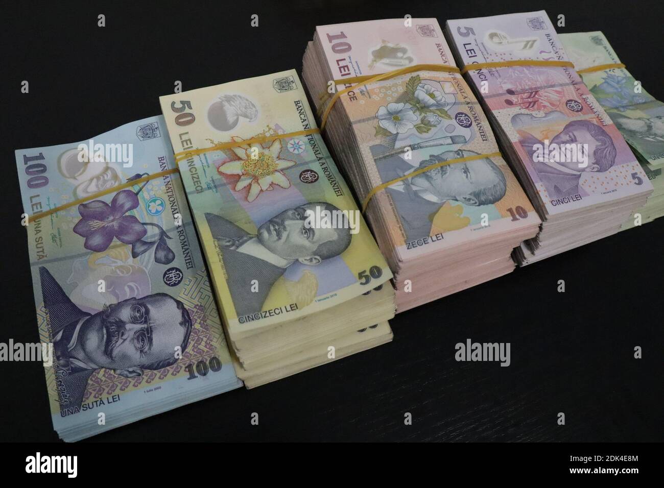 Romanian leu banknotes on a black background Stock Photo - Alamy