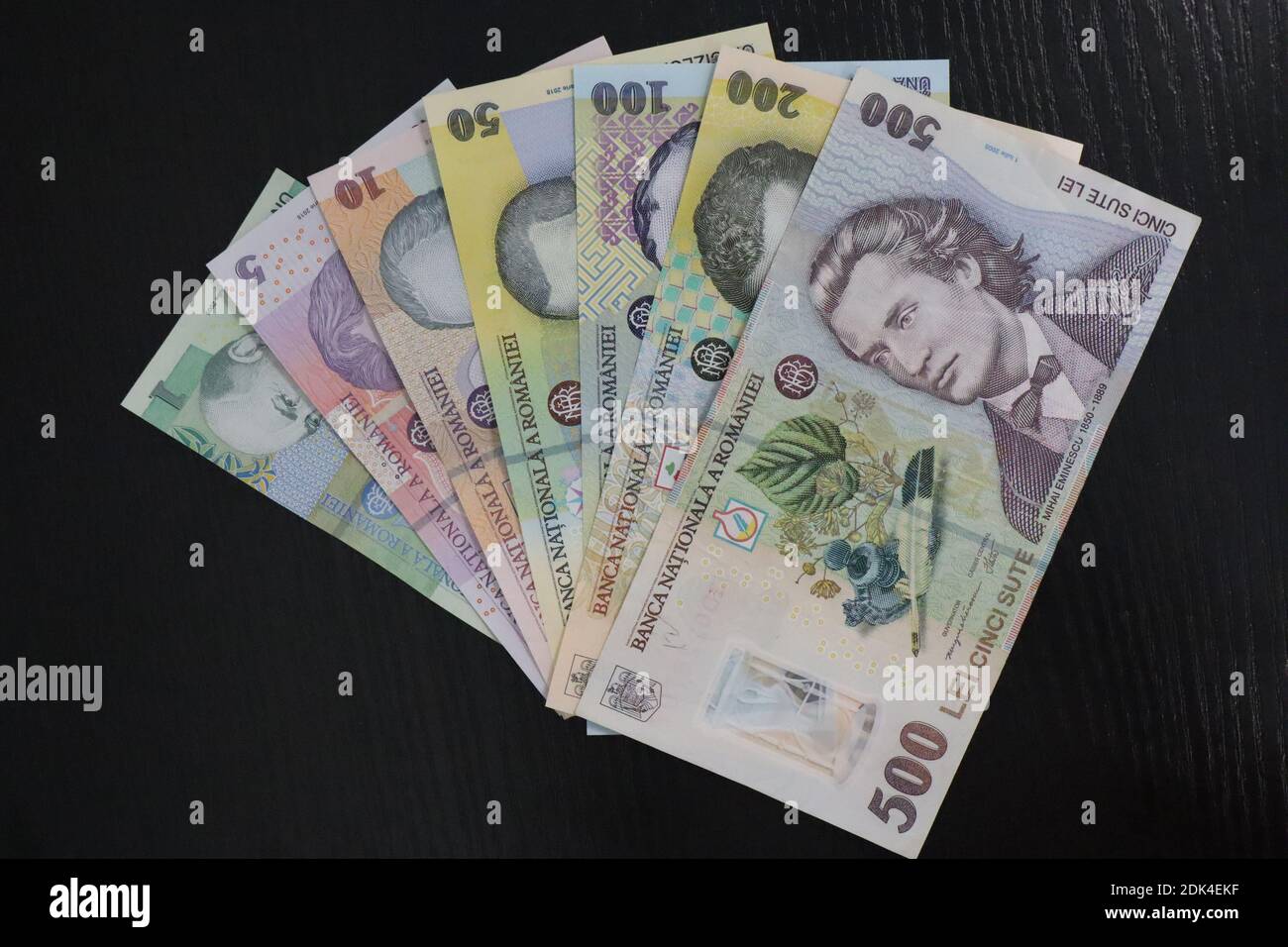 Romanian leu banknotes on a black background Stock Photo - Alamy