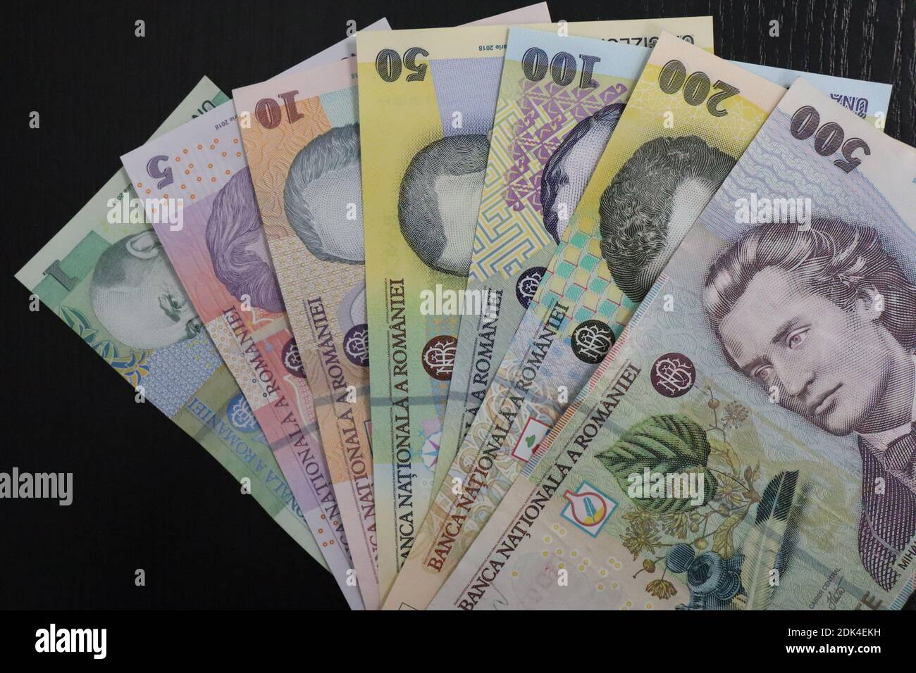 Romanian leu banknotes on a black background Stock Photo - Alamy