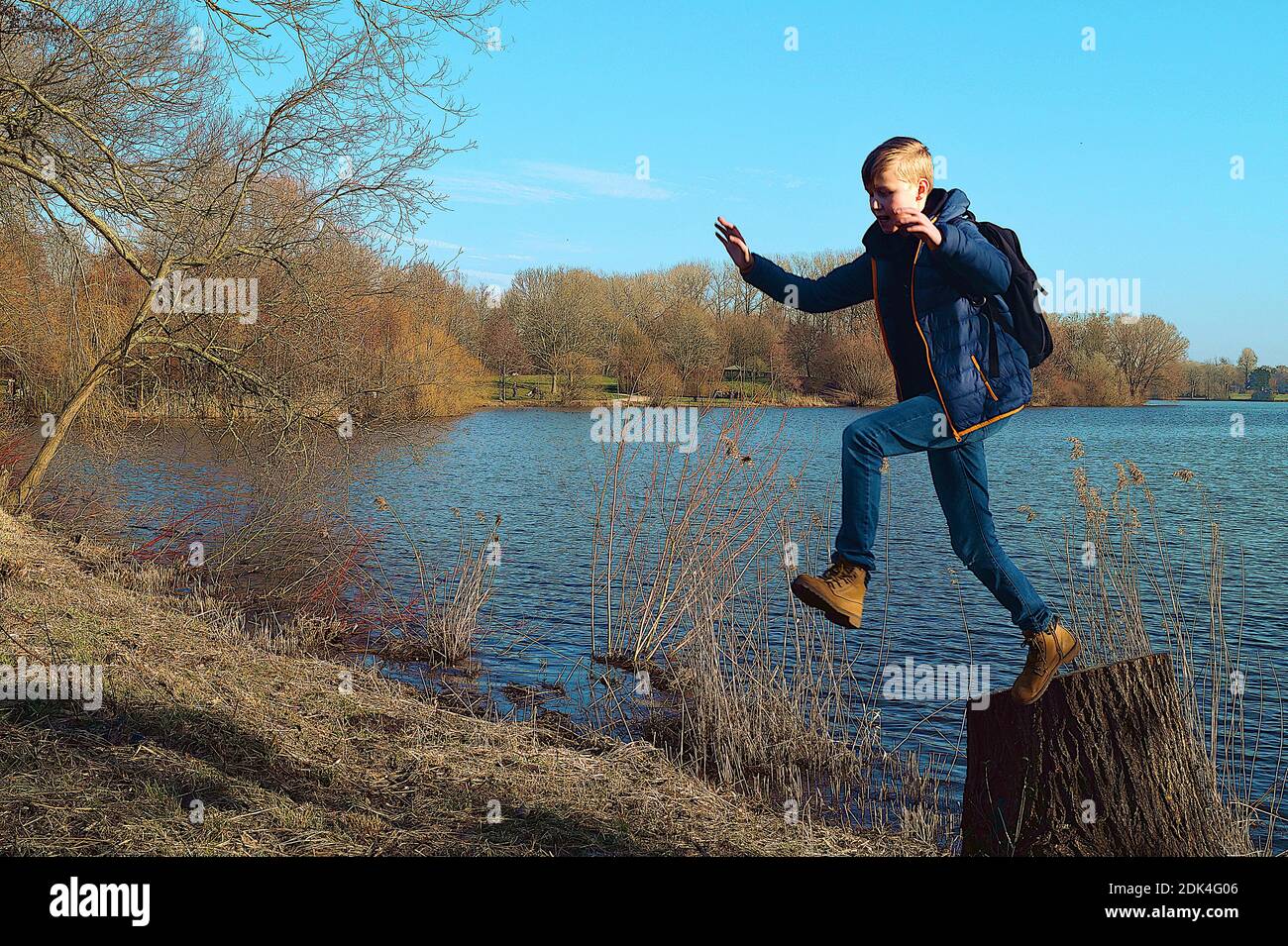 Boy jumping from tree hi-res stock photography and images - Alamy