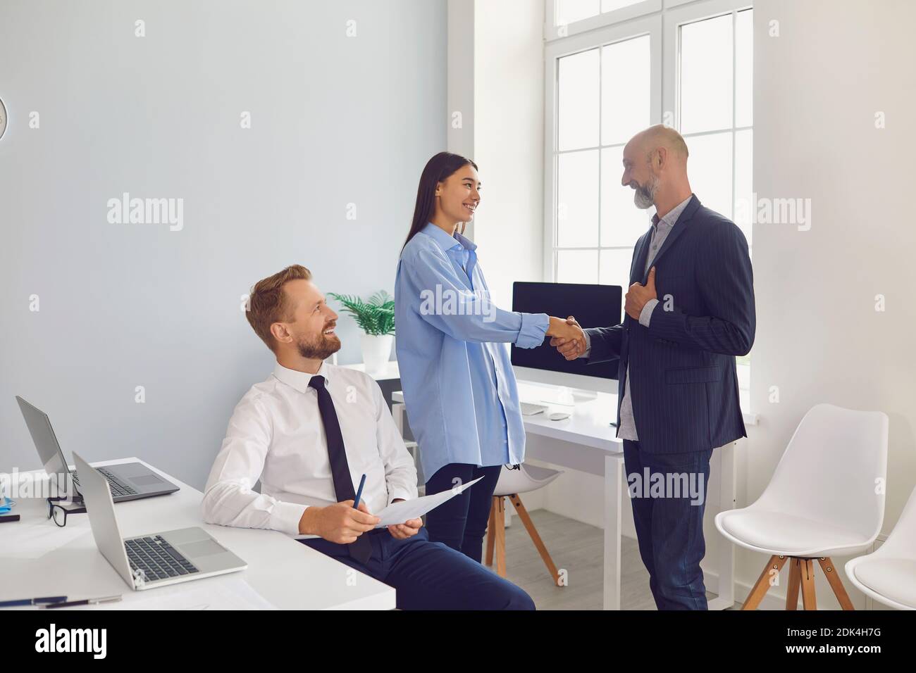 Happy mature client thanking financial advisor for help. Customer and ...