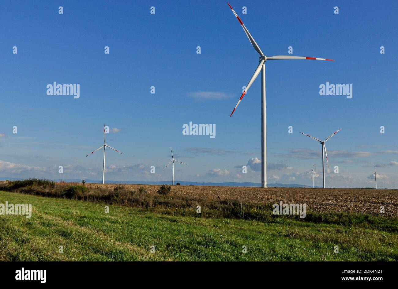 An amazing shot of wind engines in the fields under the cloudy sky ...