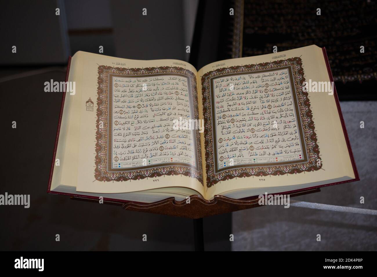 A closeup of an opened Quran book on the bookholder Stock Photo - Alamy