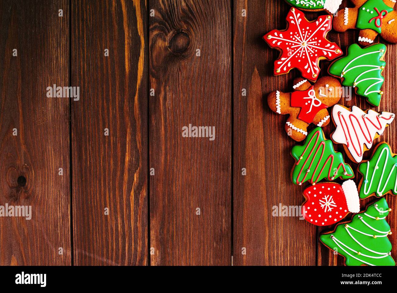 colorful ginger cookies in a bright glaze are laid out on a wooden ...