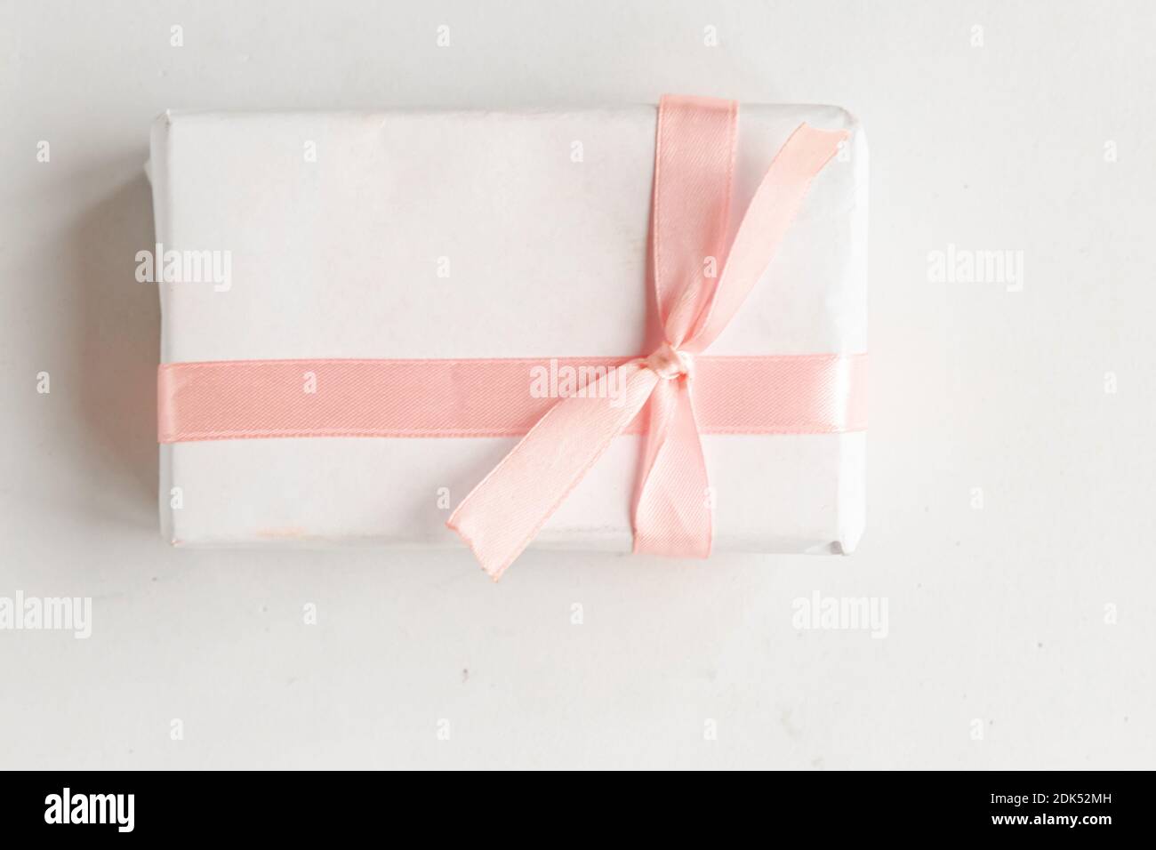 Gift box with bow on white background, top view Stock Photo - Alamy