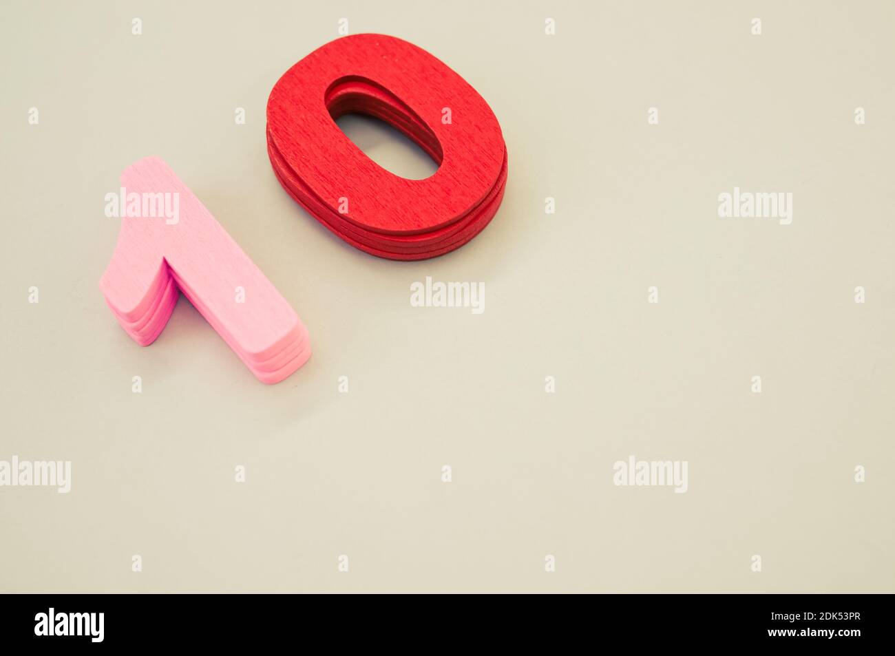 A high angle shot of the wooden numbers stacked on a white surface, the ...