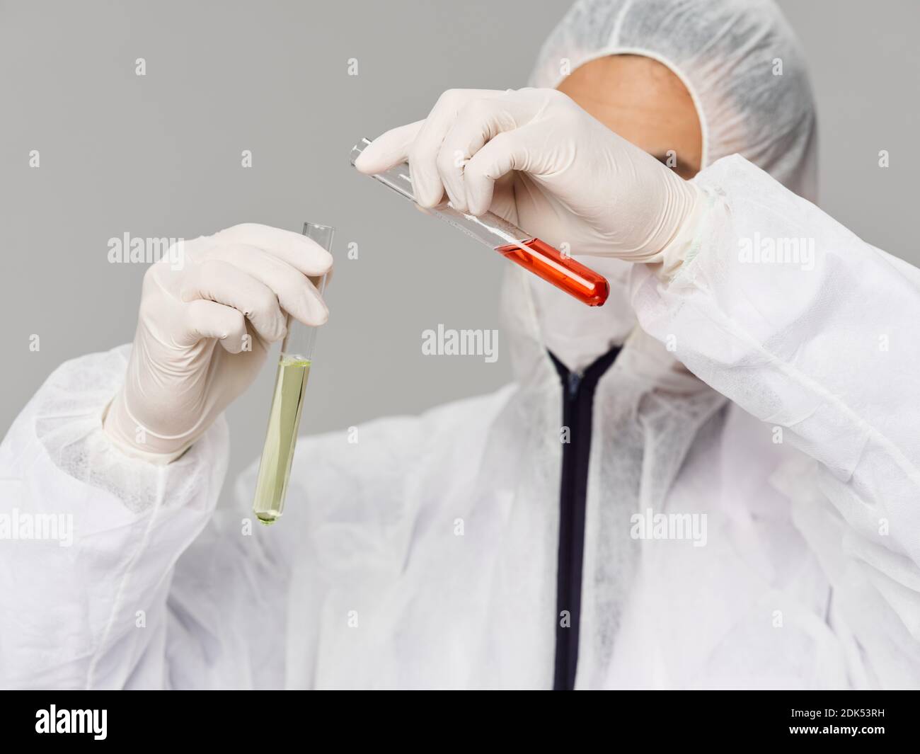 Male laboratory assistant mixes solutions vaccine development research ...