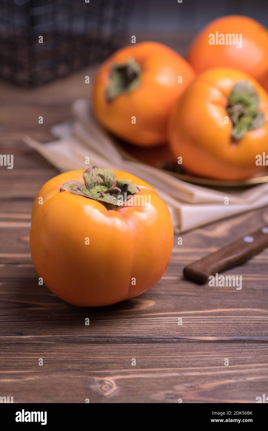 Delicious fresh orange persimmon fruit on wooden table with knife Stock ...
