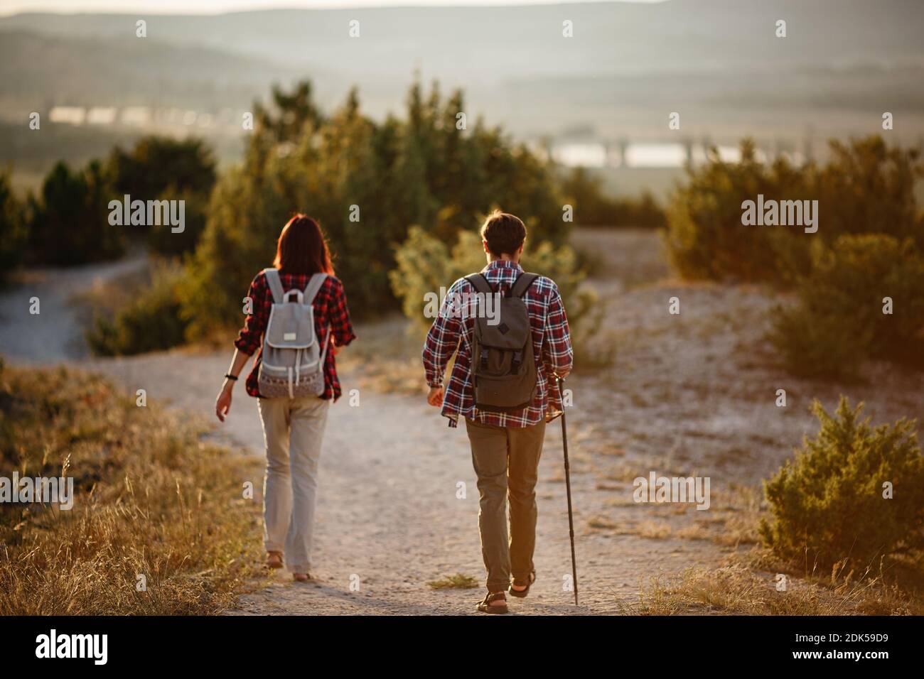 Portrait of happy young couple having fun on their hiking trip ...