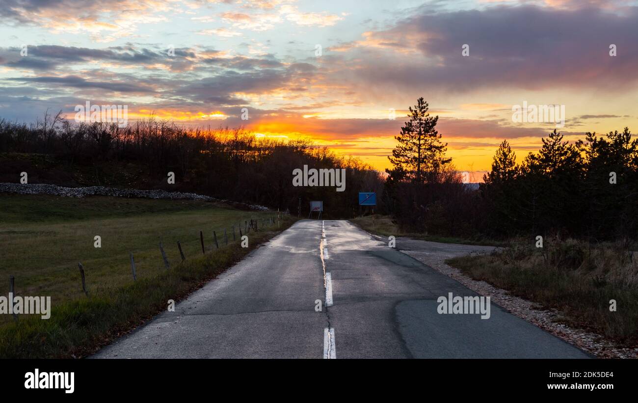 A beautiful view of an empty road with a golden sunset background Stock ...