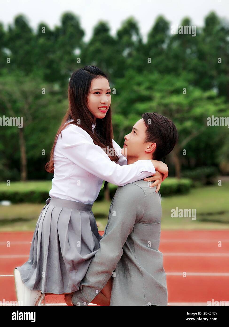 Side View Of Man Carrying Woman Stock Photo - Alamy