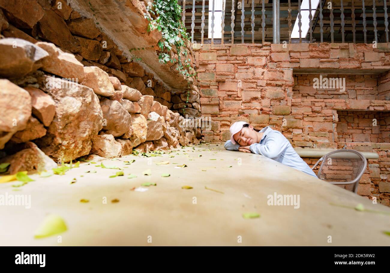 Woman sleeping on stone wall hi-res stock photography and images - Alamy
