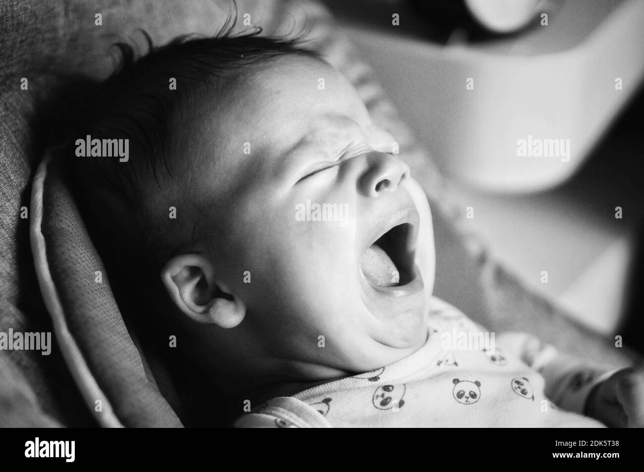 Baby lying down crying Black and White Stock Photos & Images - Alamy