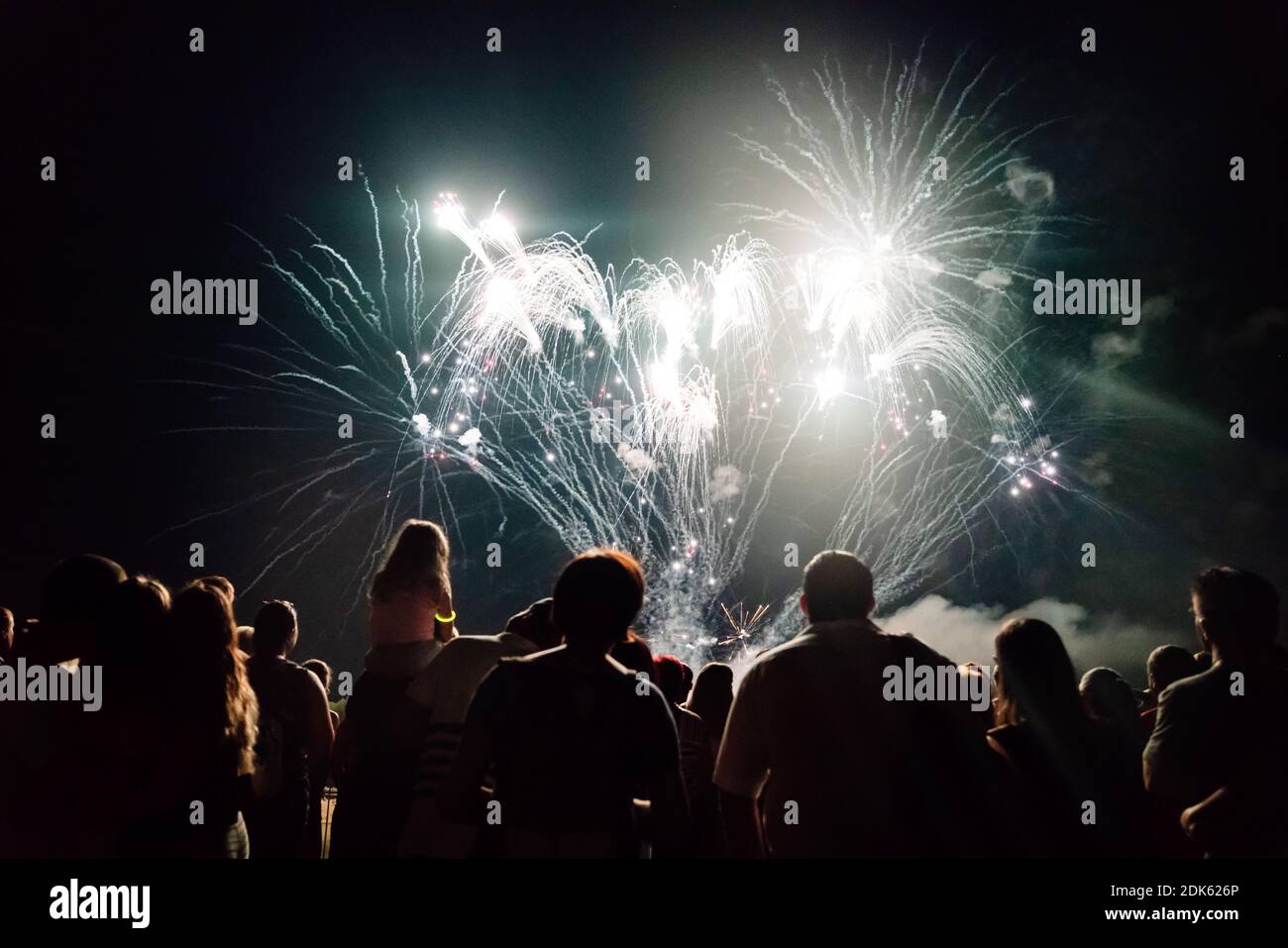 New year concept - cheering crowd and fireworks Stock Photo - Alamy