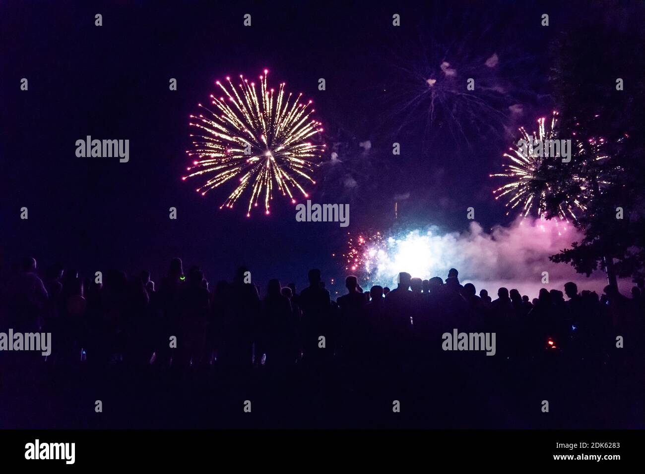 New year concept - cheering crowd and fireworks Stock Photo - Alamy