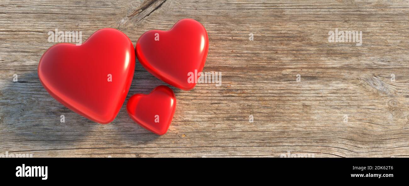 Three red hearts various size on wooden background. Family health, love ...