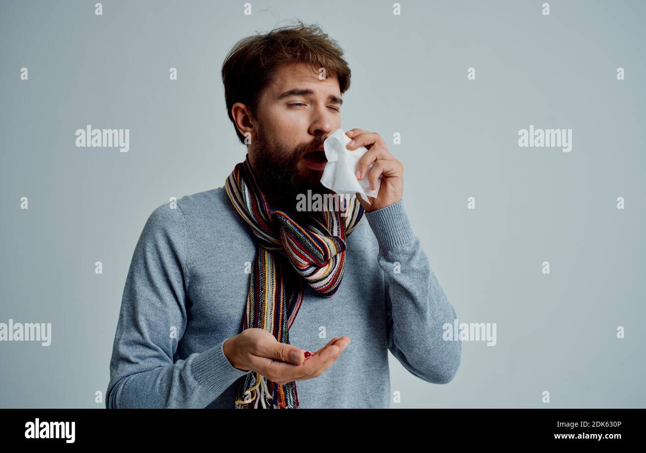 a man with a cold holding a pill health problem flu Stock Photo - Alamy