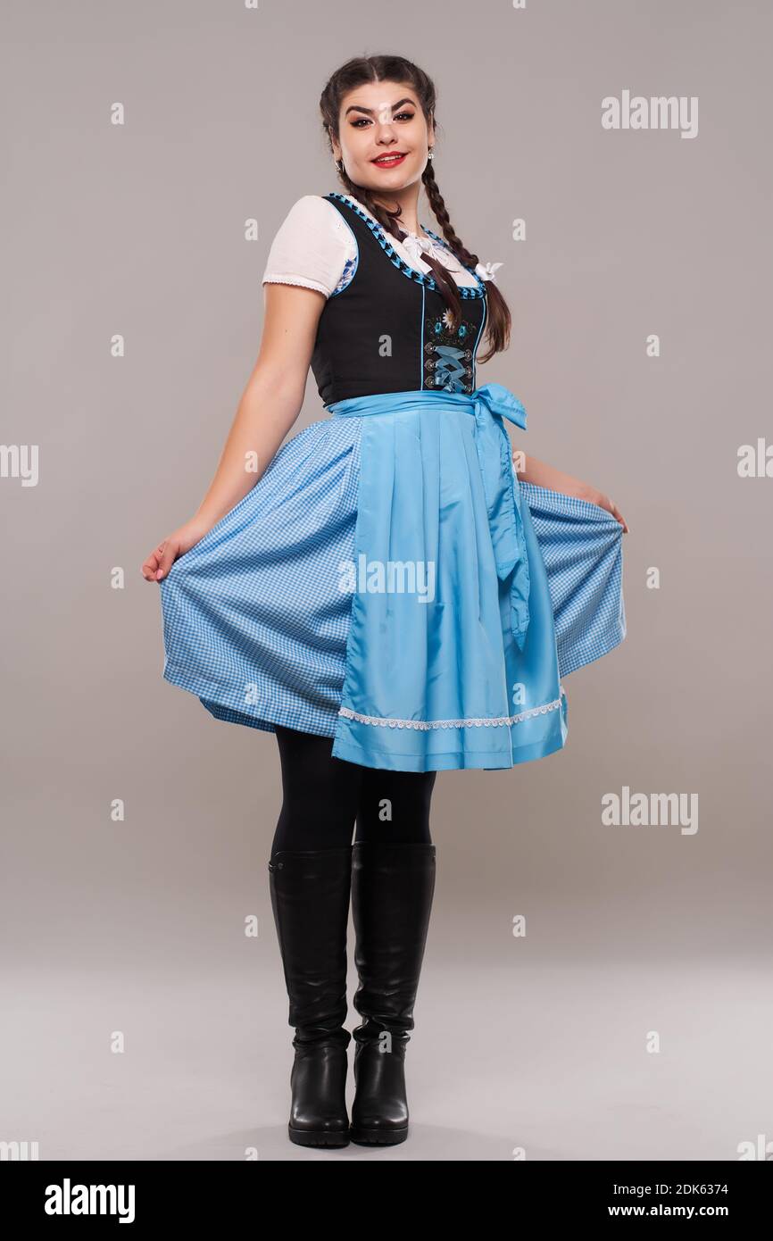 Young woman in traditional German folklore costume, isolated on gray ...