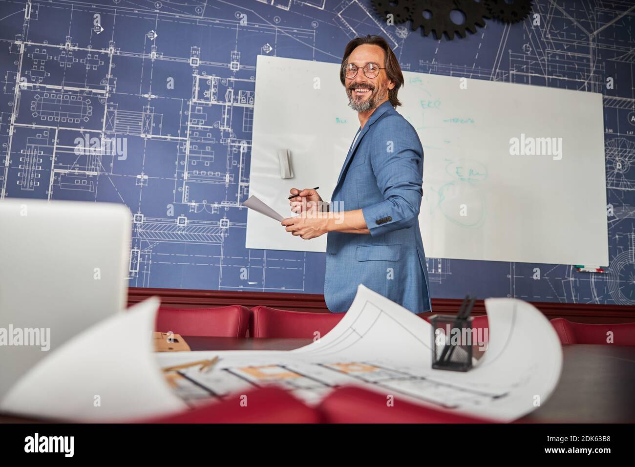 Engaging professor posing in front of the class Stock Photo - Alamy