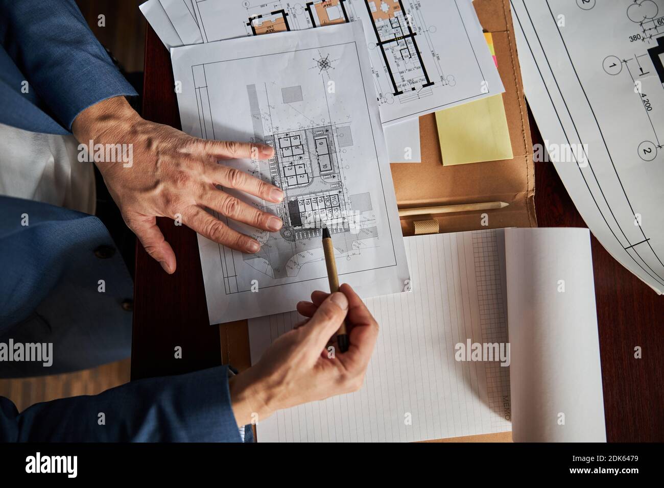 Office employee working with some paperwork at his desk Stock Photo - Alamy
