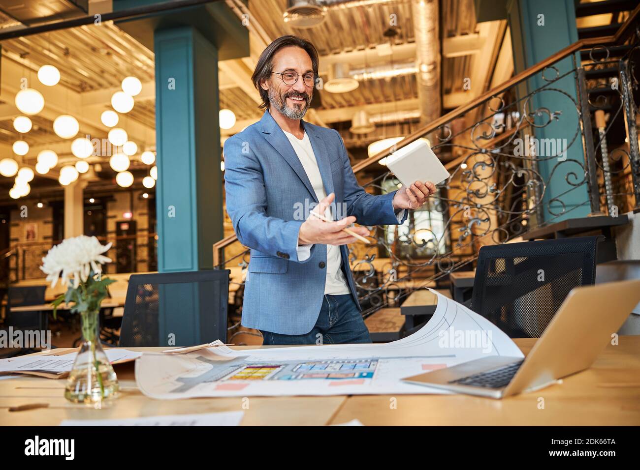 Enthusiastic man explaining his project via video-call Stock Photo - Alamy