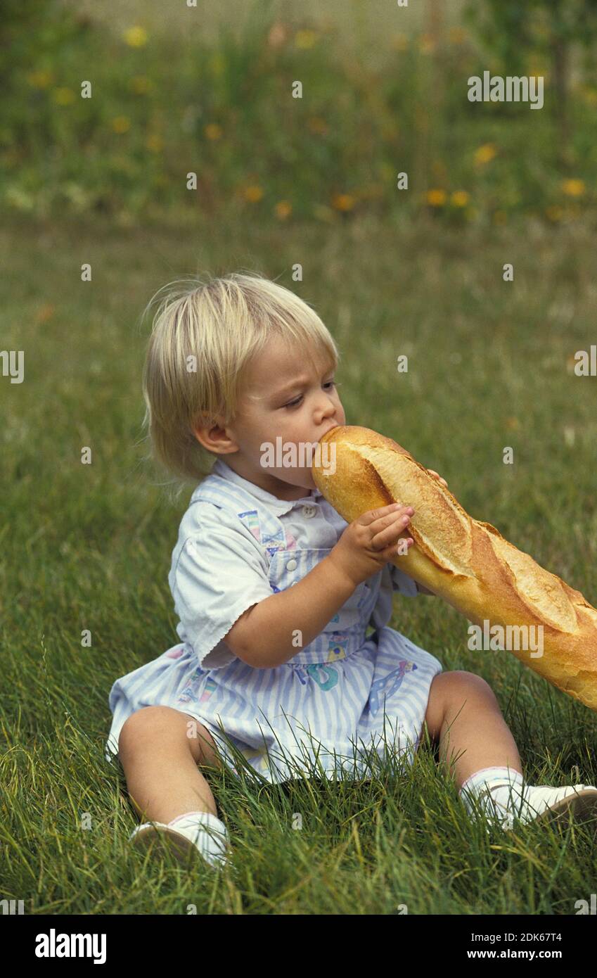 Girl eating French Bread Stick Stock Photo - Alamy