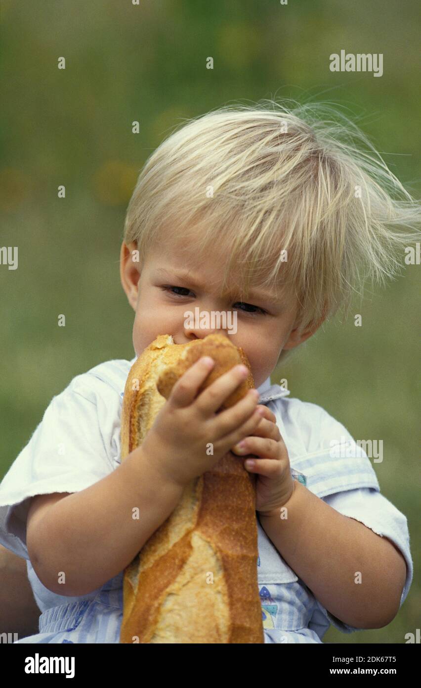 Girl eating French Bread Stick Stock Photo - Alamy