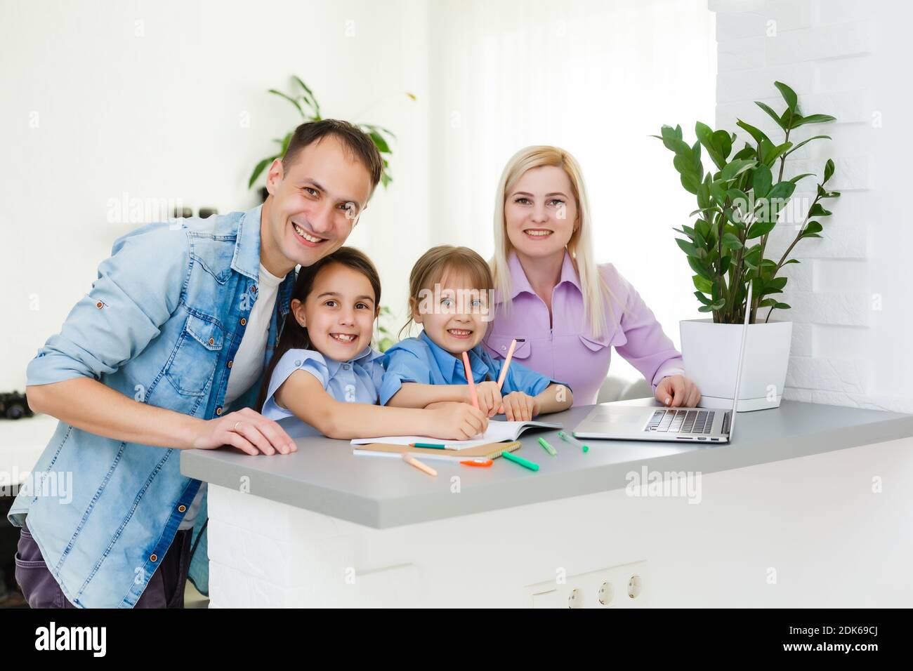 Family Working At Laptop With In Home Office Stock Photo - Alamy