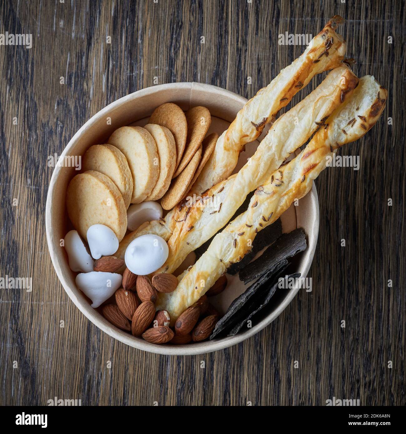 various cookies in cardboard cup on wooden table, top view Stock Photo ...