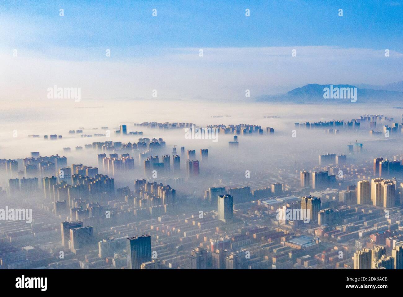 The advection clouds flow slowly between the urban buildings, looming ...