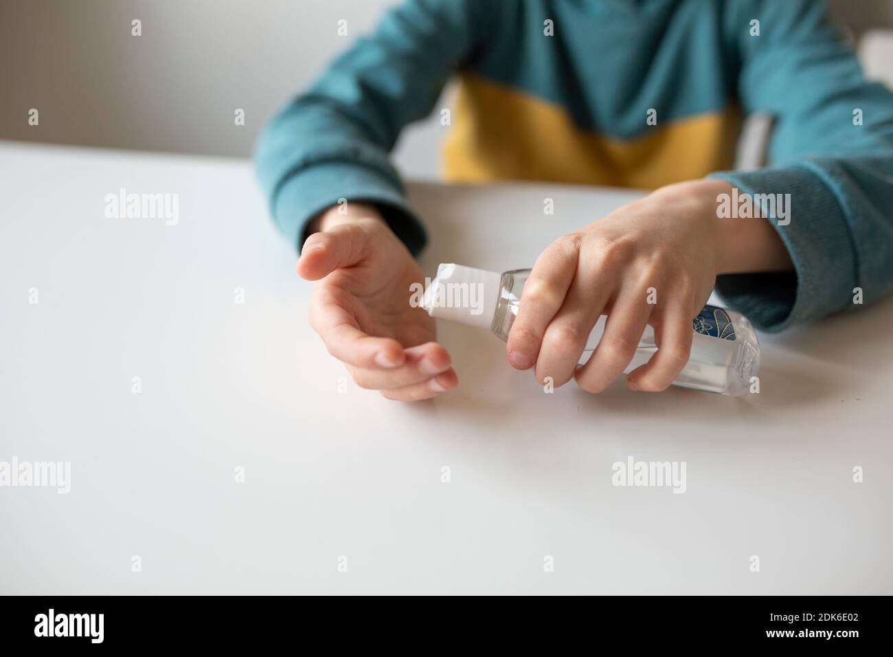 Man puts hand alcohol on his hands Stock Photo - Alamy