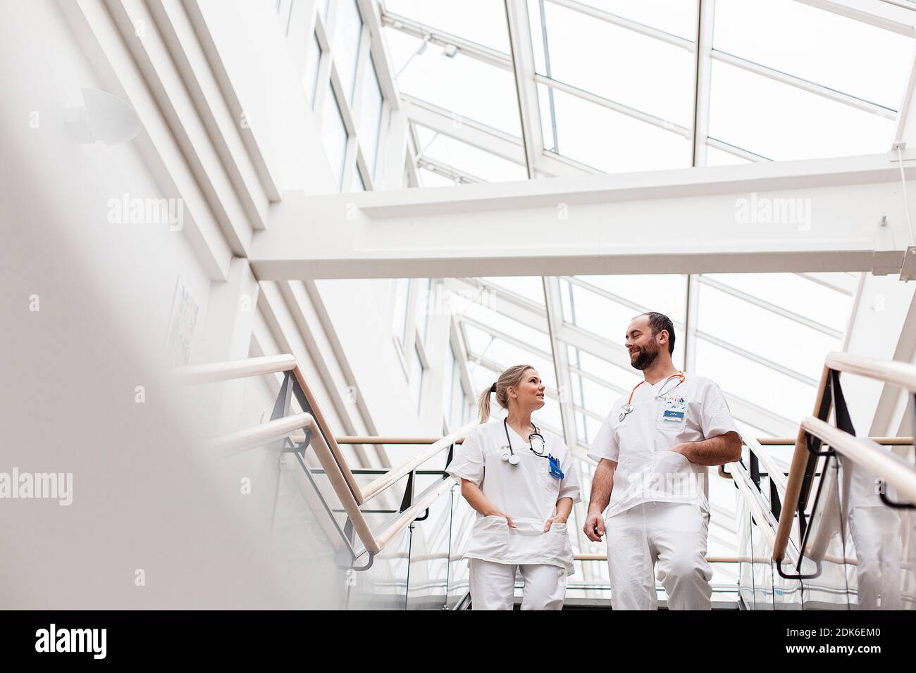 Doctors talking on hospital corridor Stock Photo - Alamy