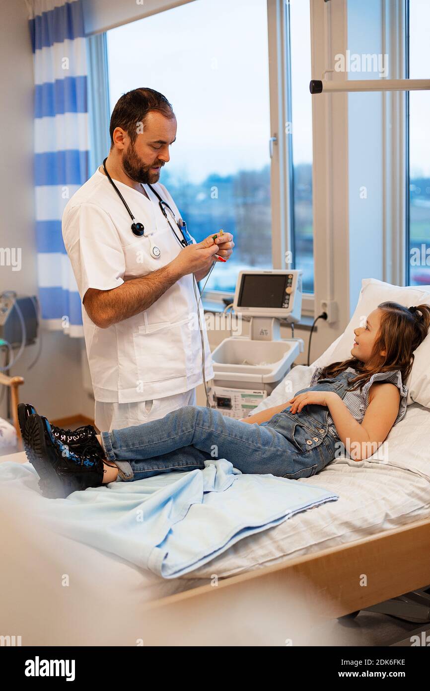 Doctor examining patient Stock Photo - Alamy