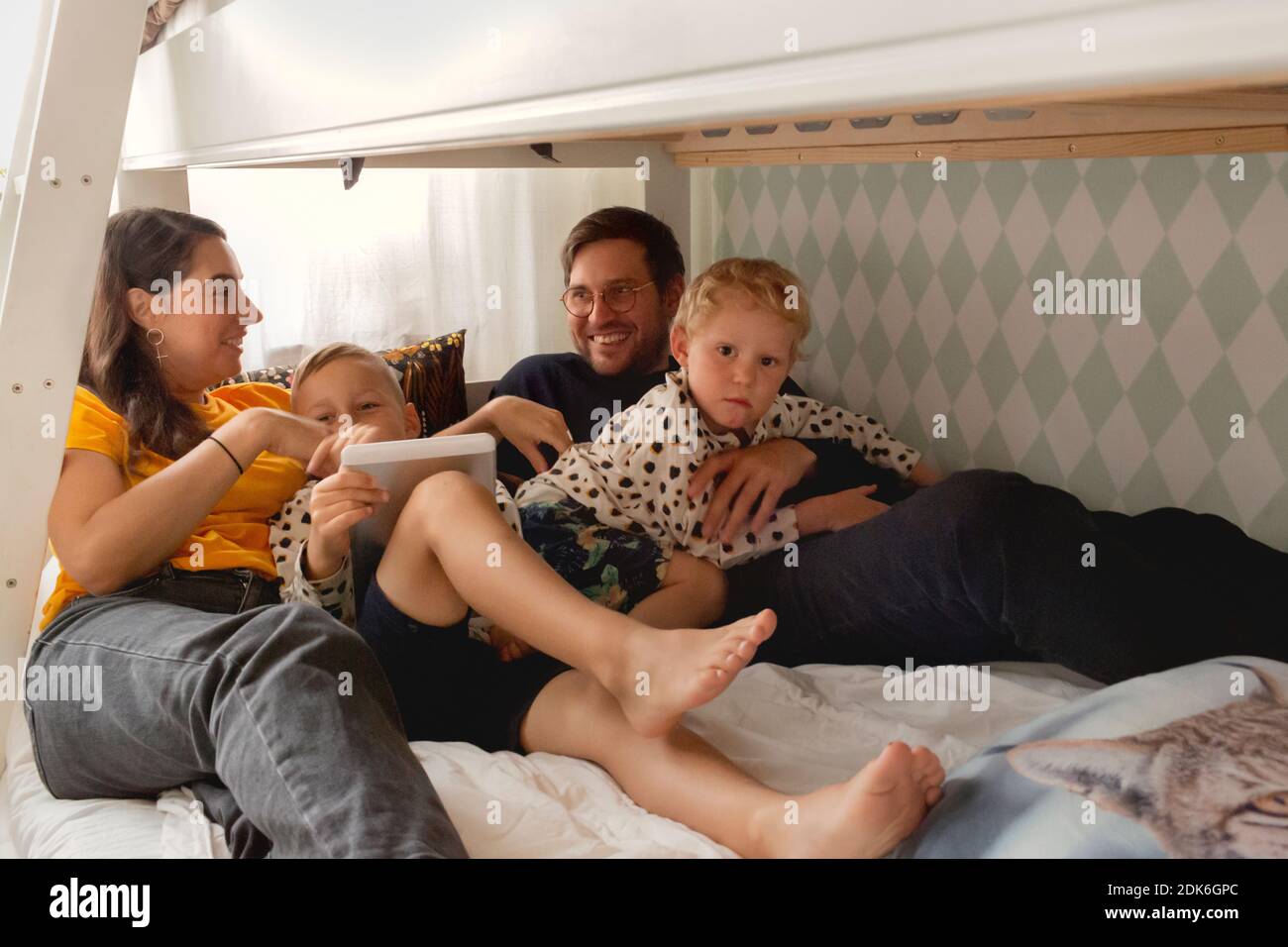 Parents with sons on bed Stock Photo - Alamy