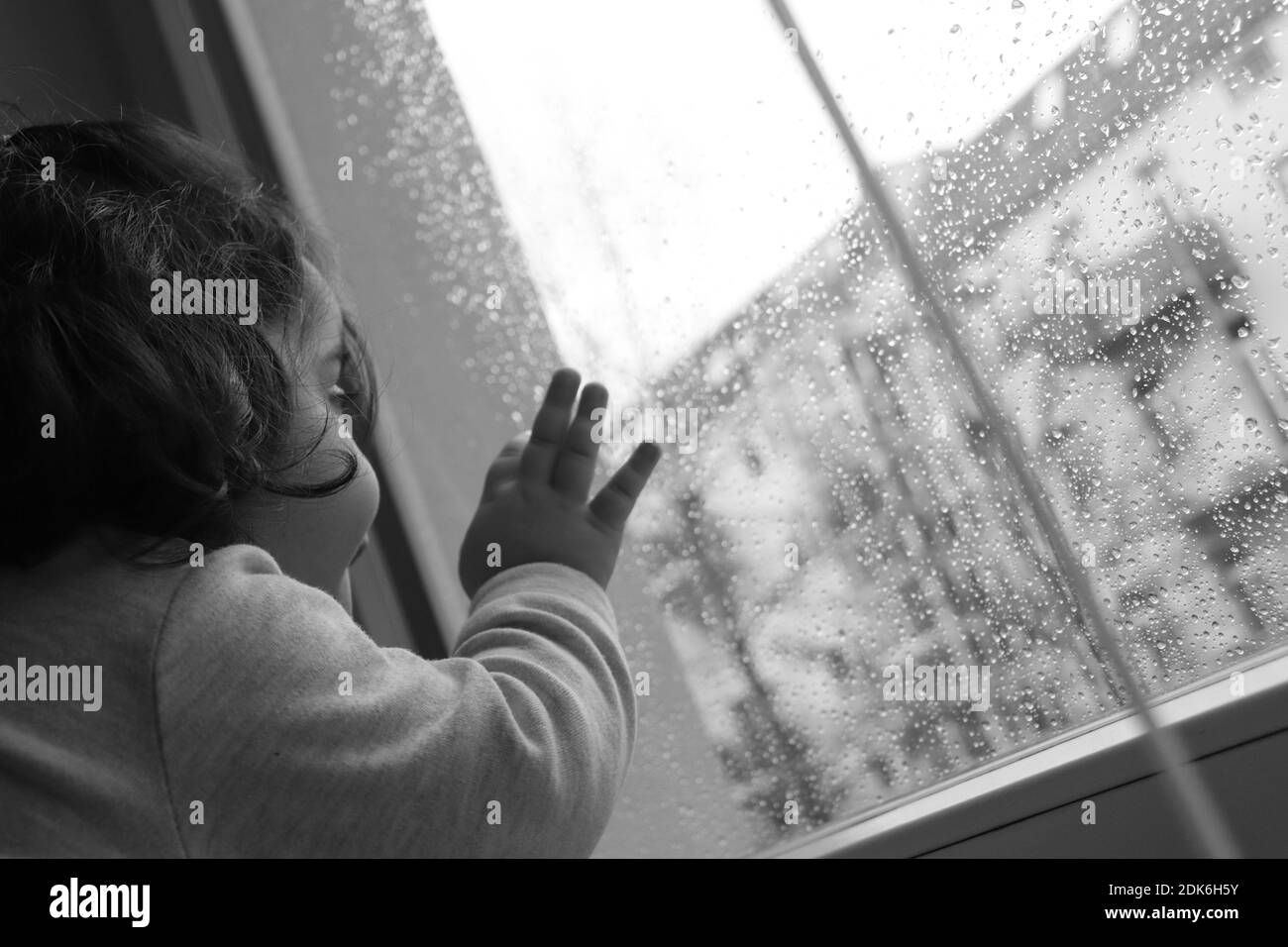 Girl Looking Through Glass Window Stock Photo - Alamy