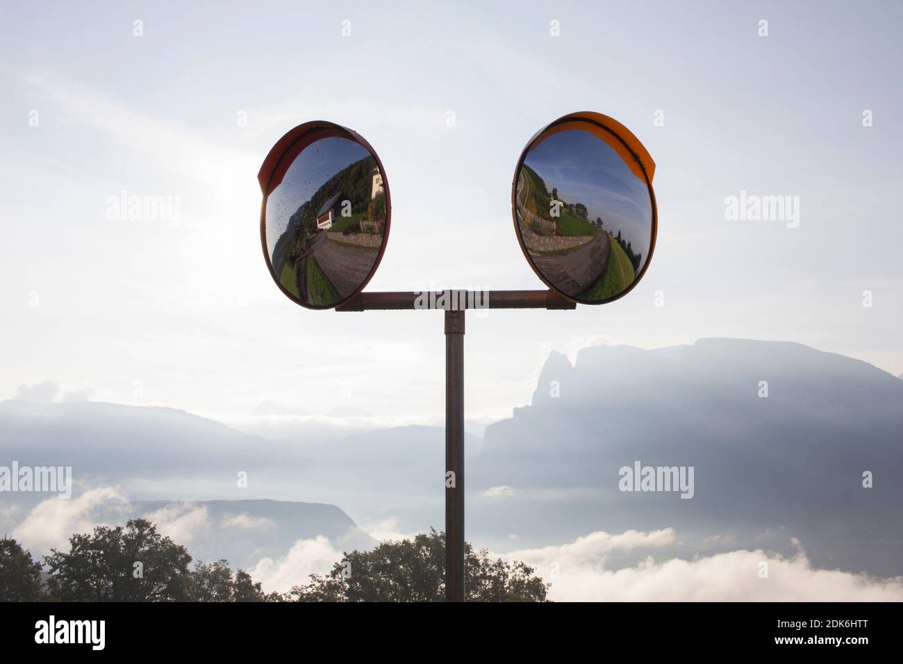 Round mirror in front of a mountain backdrop in South Tyrol Stock Photo ...