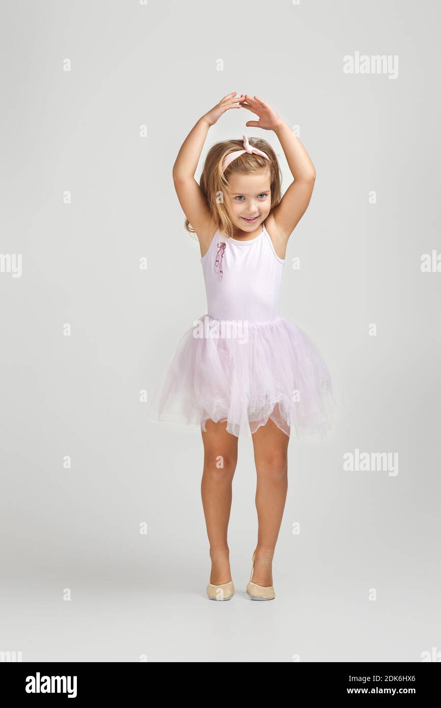 little child girl dreams of becoming a ballerina. ballet dancer in pink ...