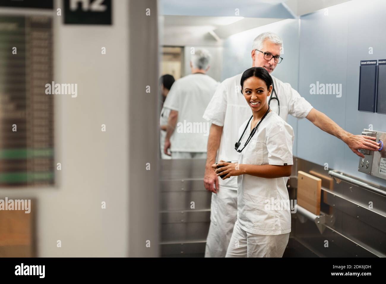 Doctors standing in lift Stock Photo - Alamy