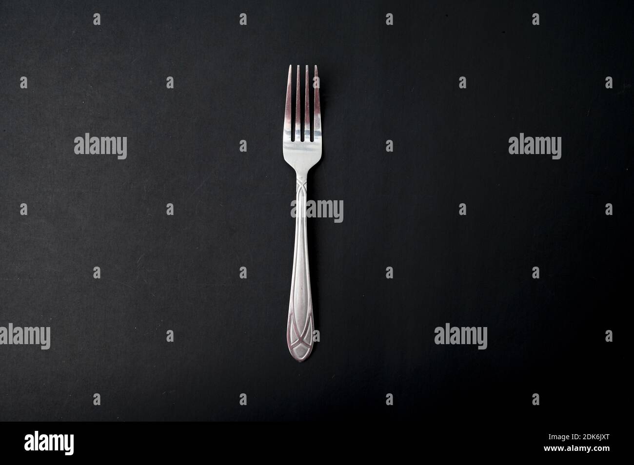 A top view of the fork on a black background Stock Photo - Alamy