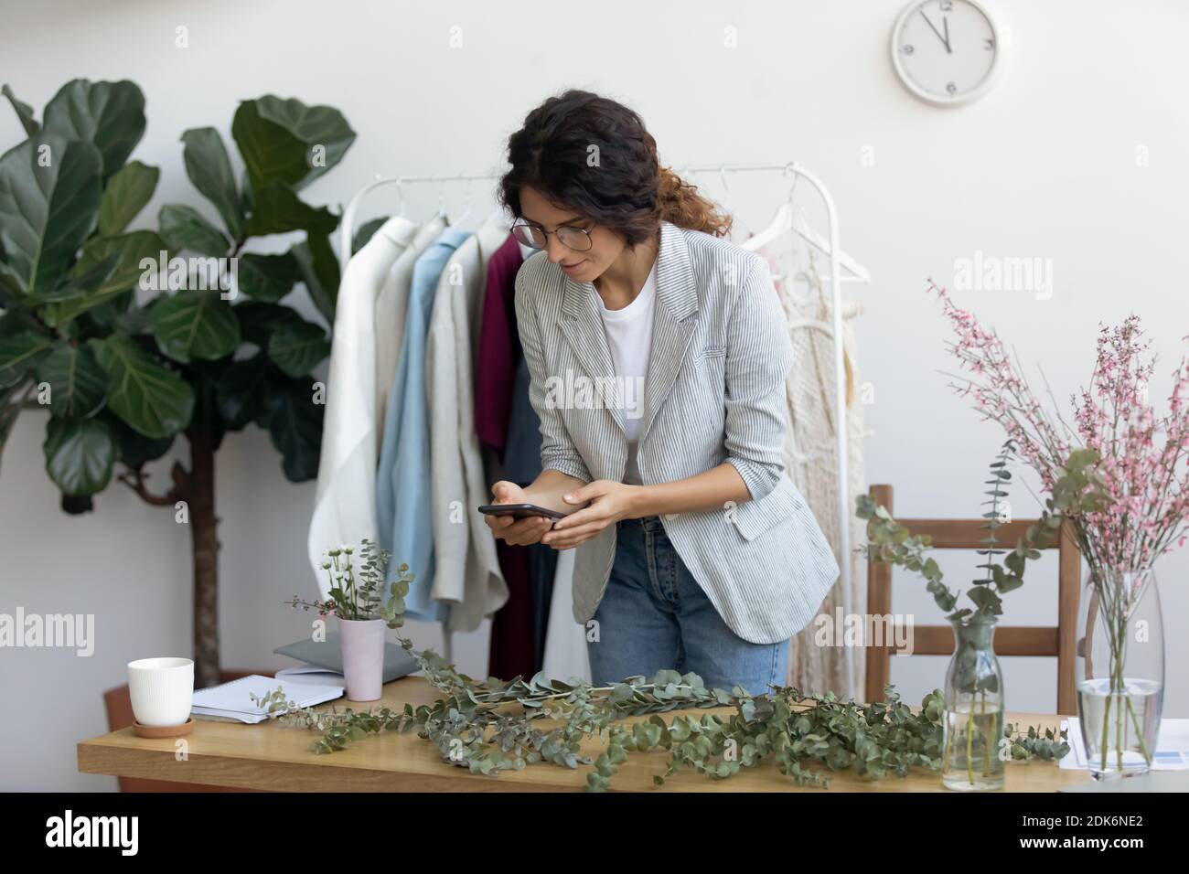 Skilled millennial woman florist preparing tutorial of creating flower ...
