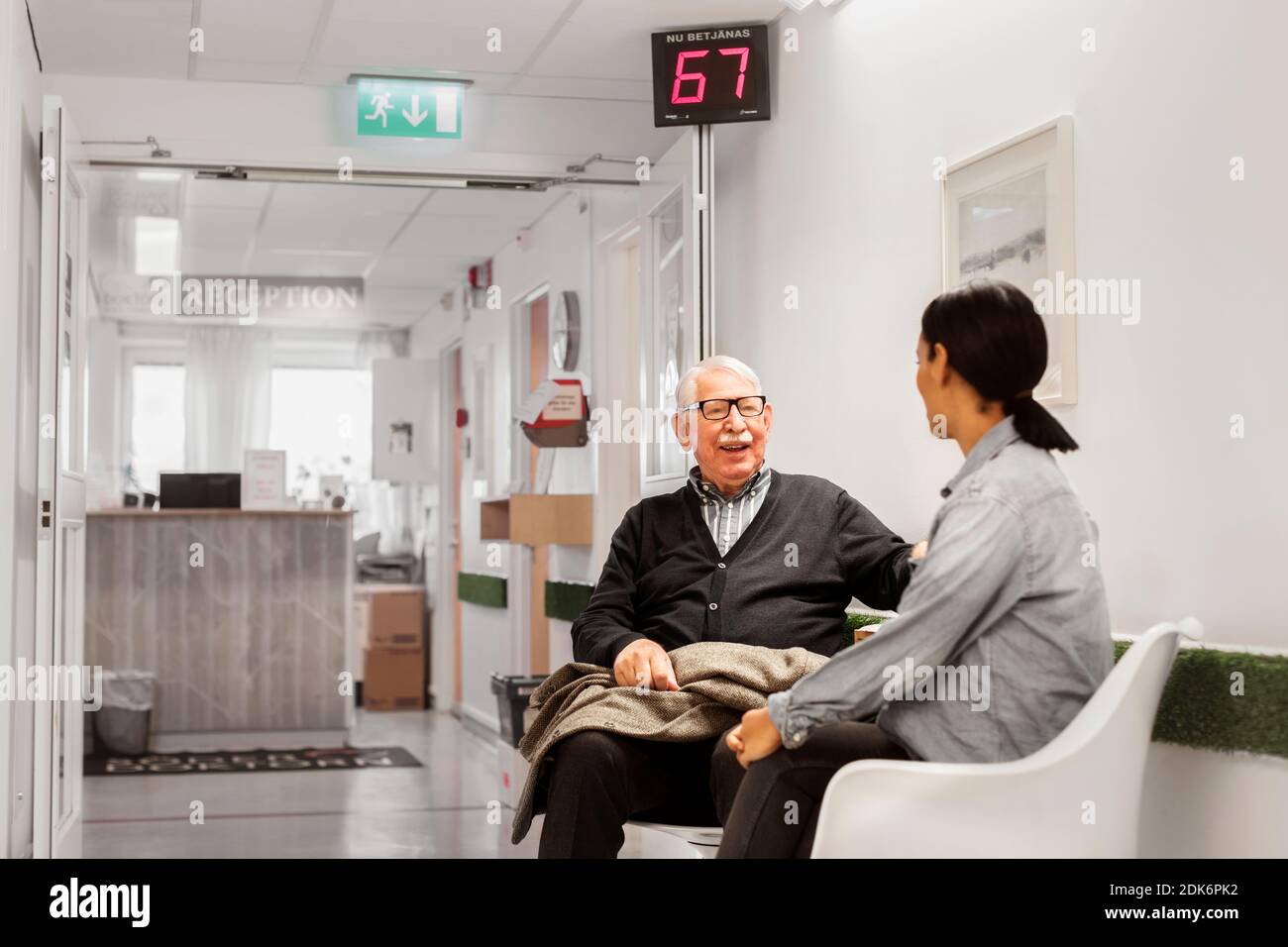 Patients sitting in surgery waiting room Stock Photo - Alamy