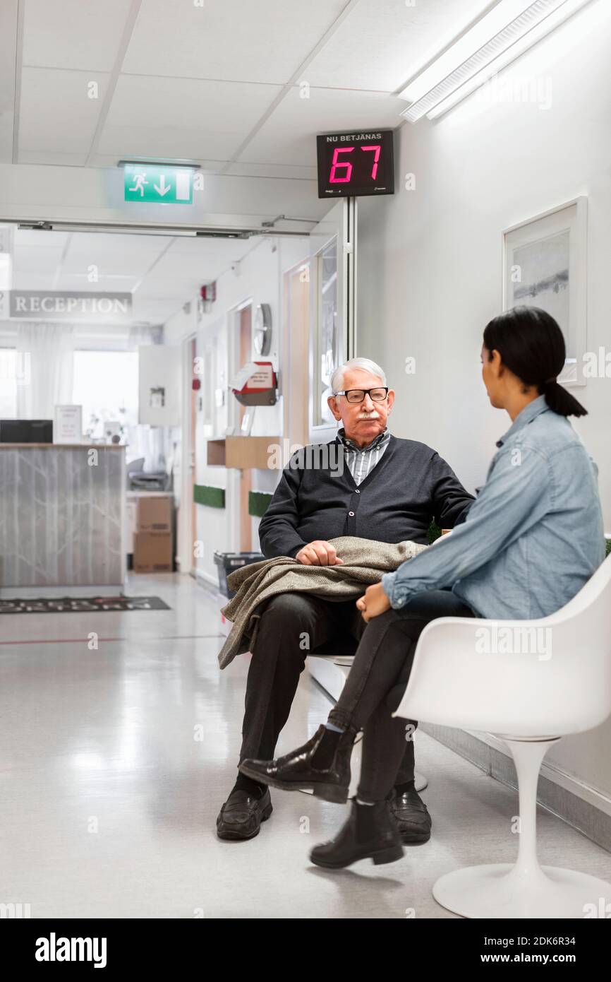 Patients sitting in surgery waiting room Stock Photo - Alamy