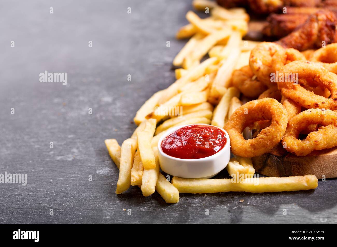 fast food products : onion rings, french fries and fried chicken on ...