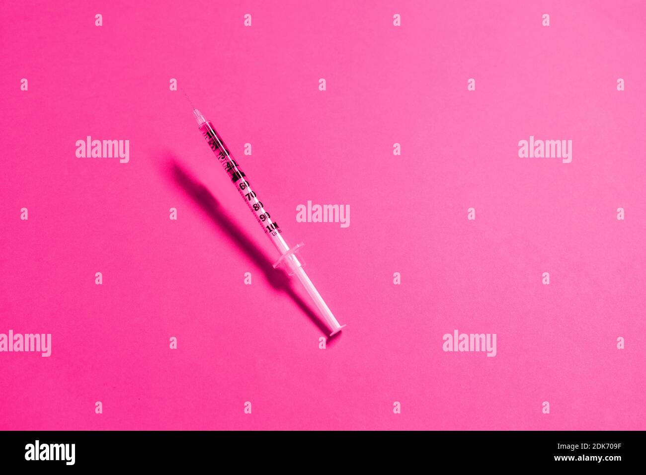 Syringes with transparent medicine liquid on isolated pink background ...